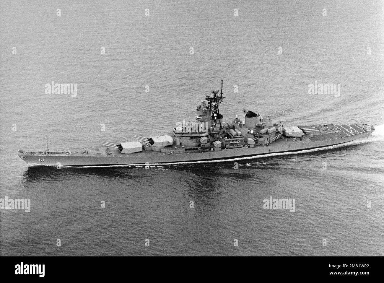 An elevated port beam view of the battleship USS IOWA (BB 61) underway during sea trials ...