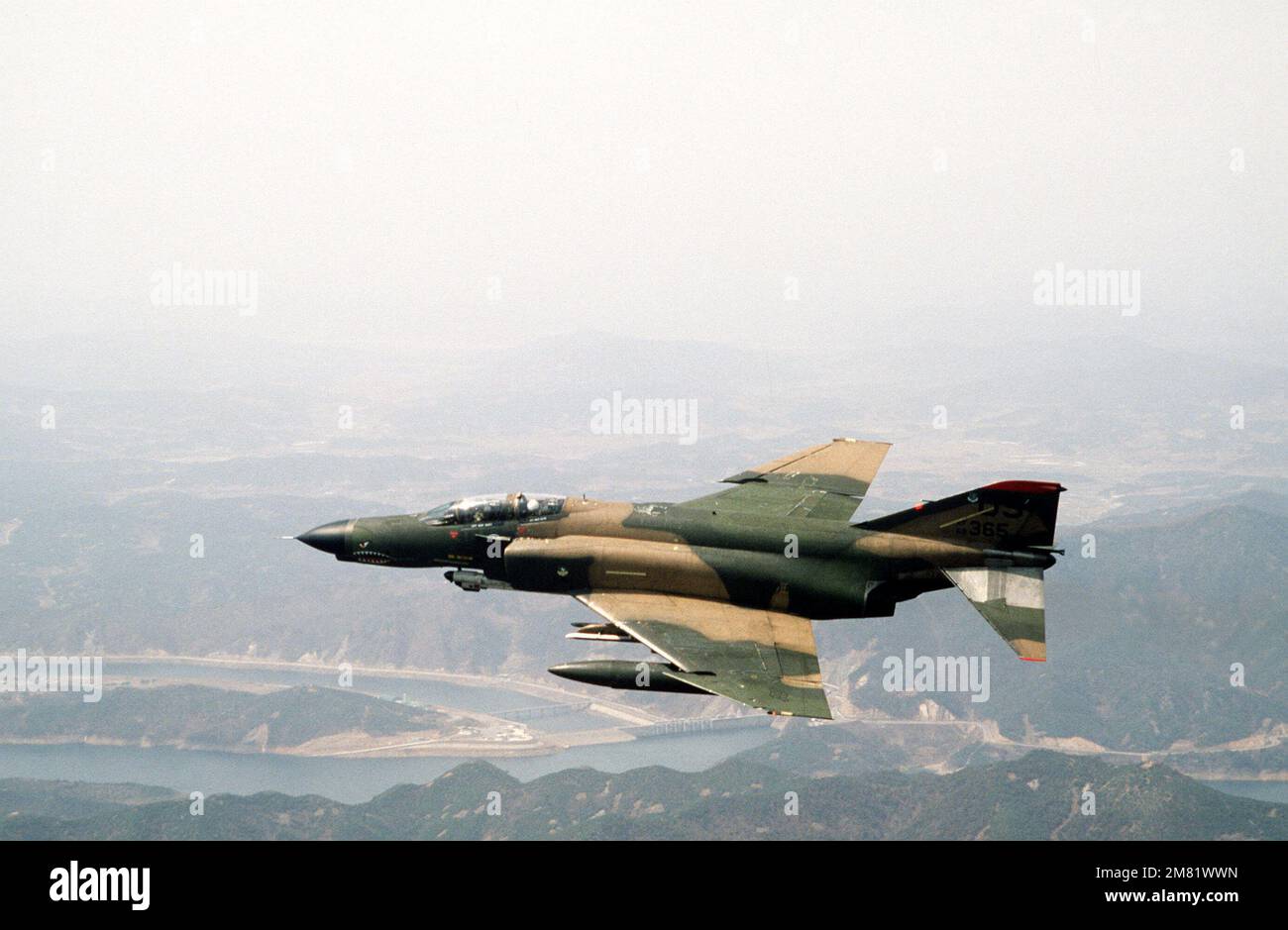 An air-to-air left side view of four F-4E Phantom II aircraft from the ...