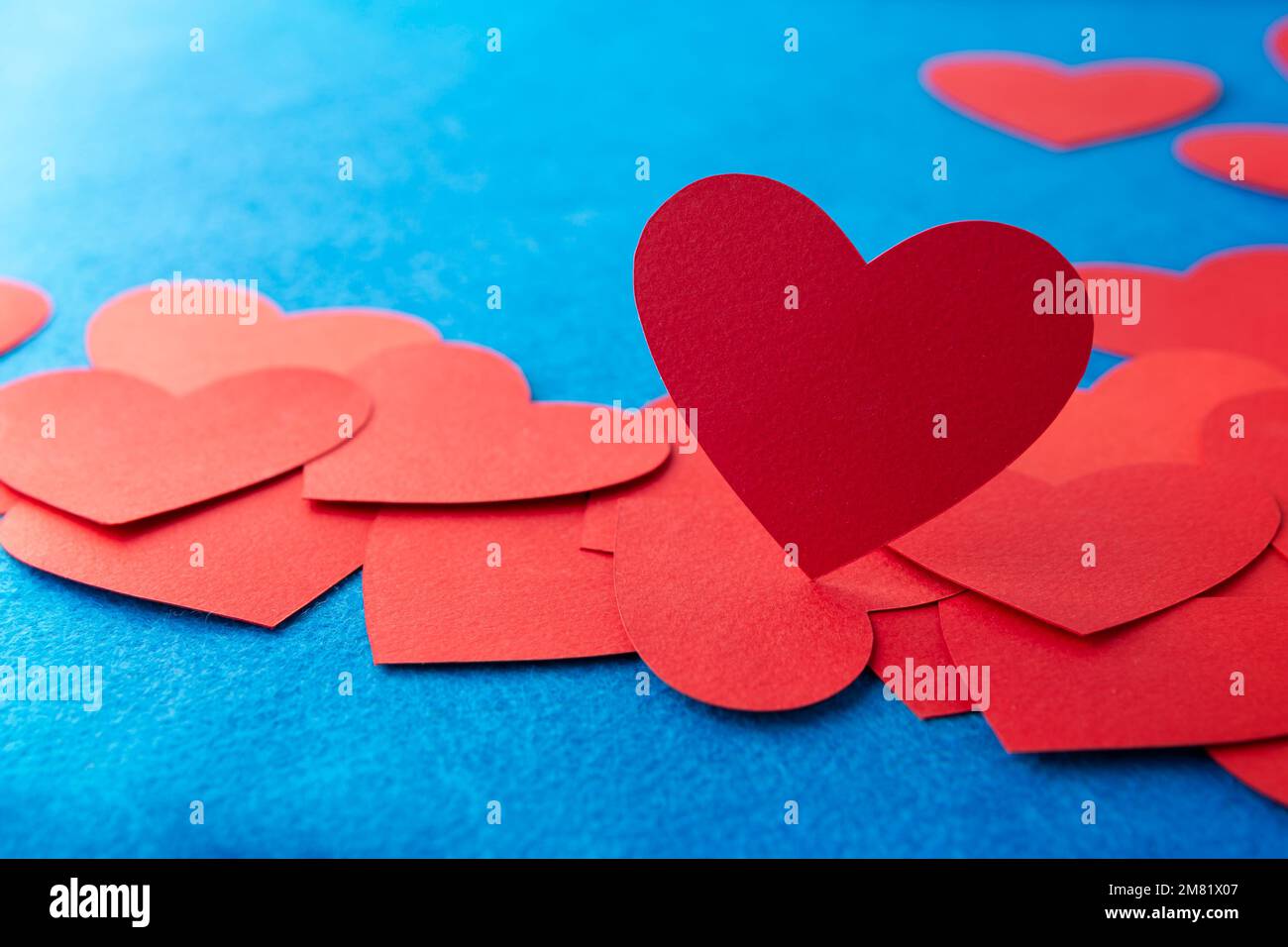 Red paper heart shape on blue textured background with copy space. Love ...