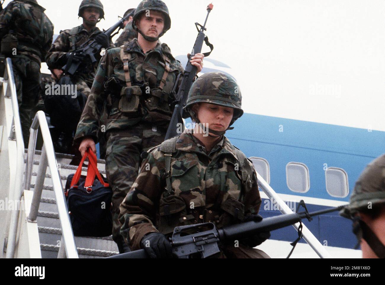 U.S. soldiers exit a Boeing 747 aircraft upon their arrival to ...