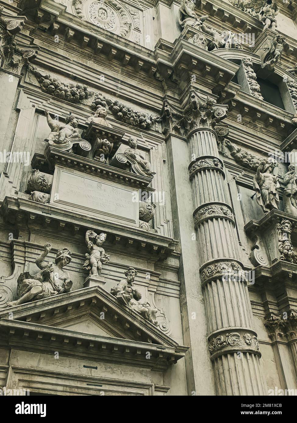 A vertical of statues and sculptures on a wall of an ancient building ...