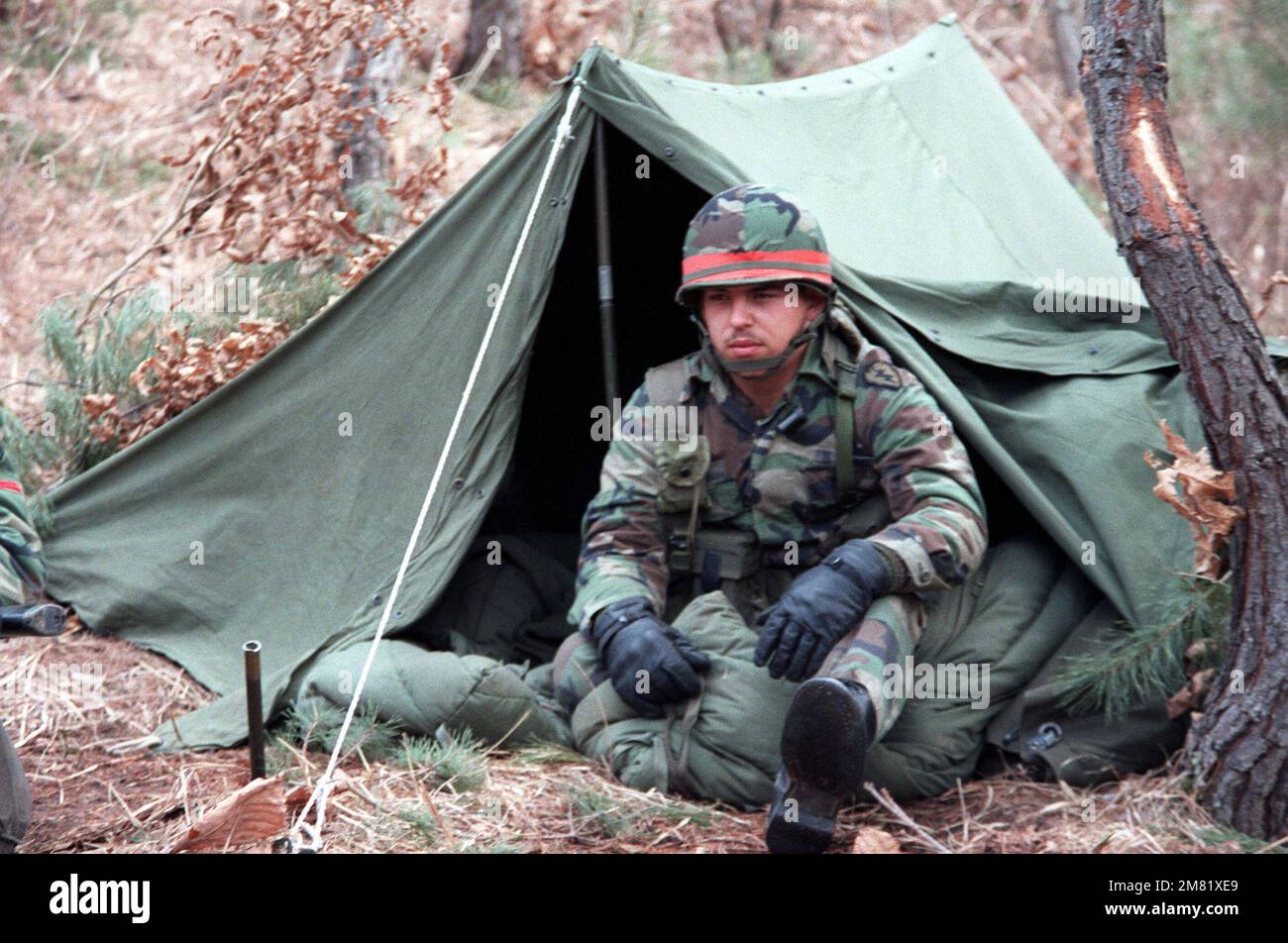 A member of the 15th Infantry Division (Tropic Lightning) sits outside ...