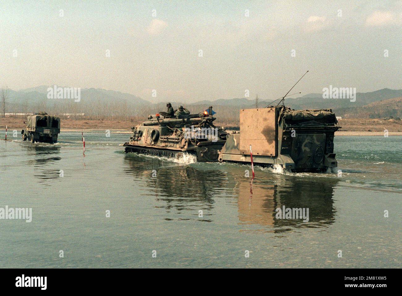 An M-577 command post vehicle (right), an M-88 armored recovery vehicle ...