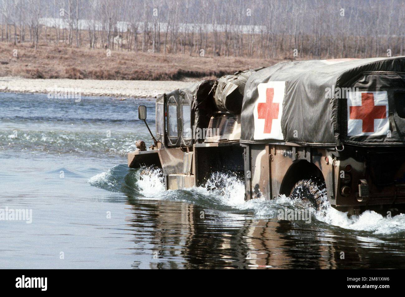 An M792 1 1/4-ton truck crosses a stream during Exercise TEAM SPIRIT 84 ...