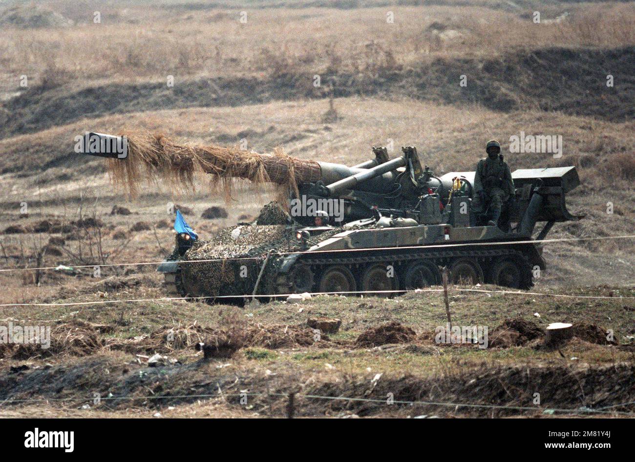 An M-110 203 mm (8-inch) self-propelled howitzer is driven across a ...