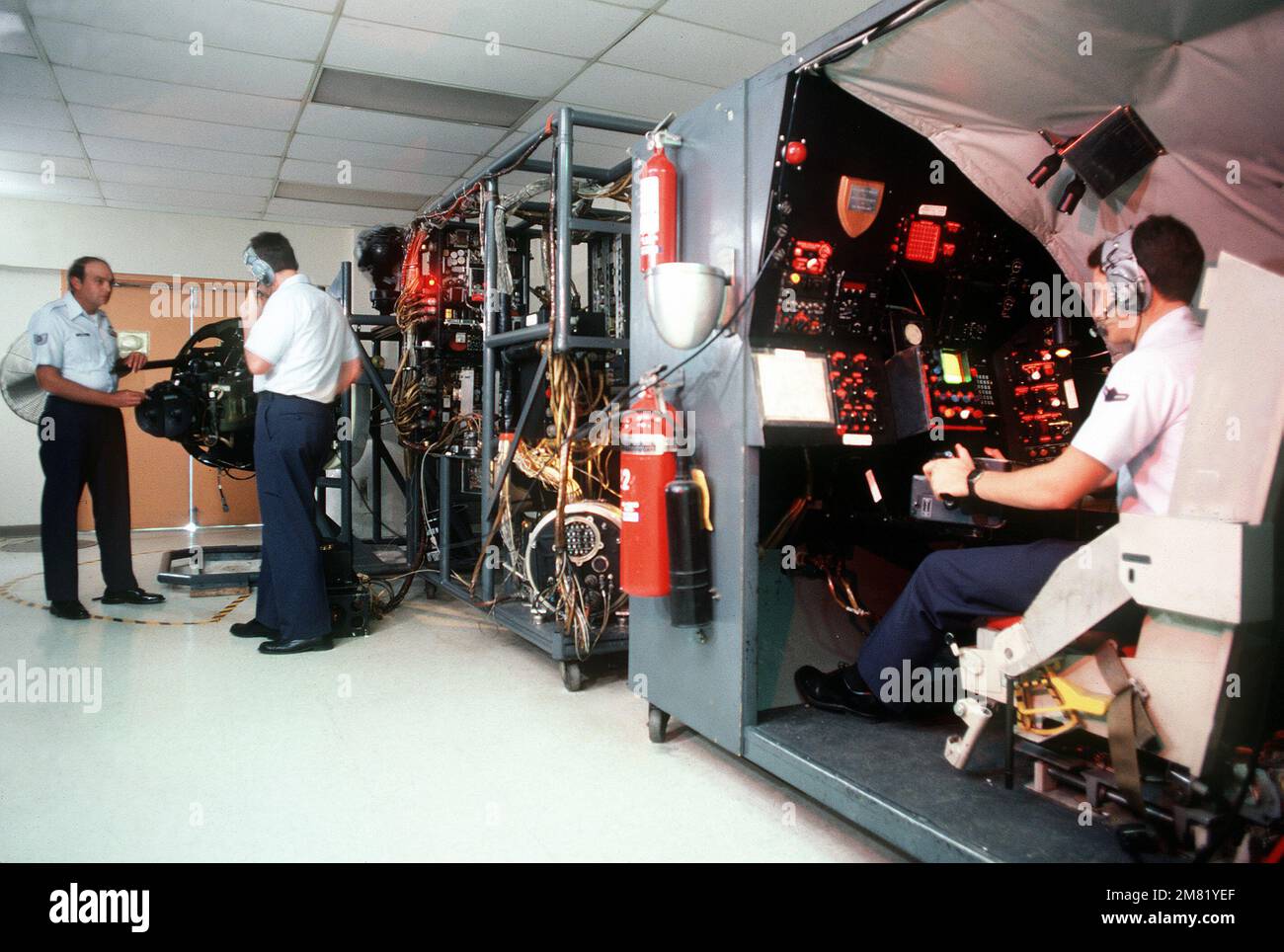 AIRMAN Zachary Peters mans the controls of a B-52 gunnery system ...