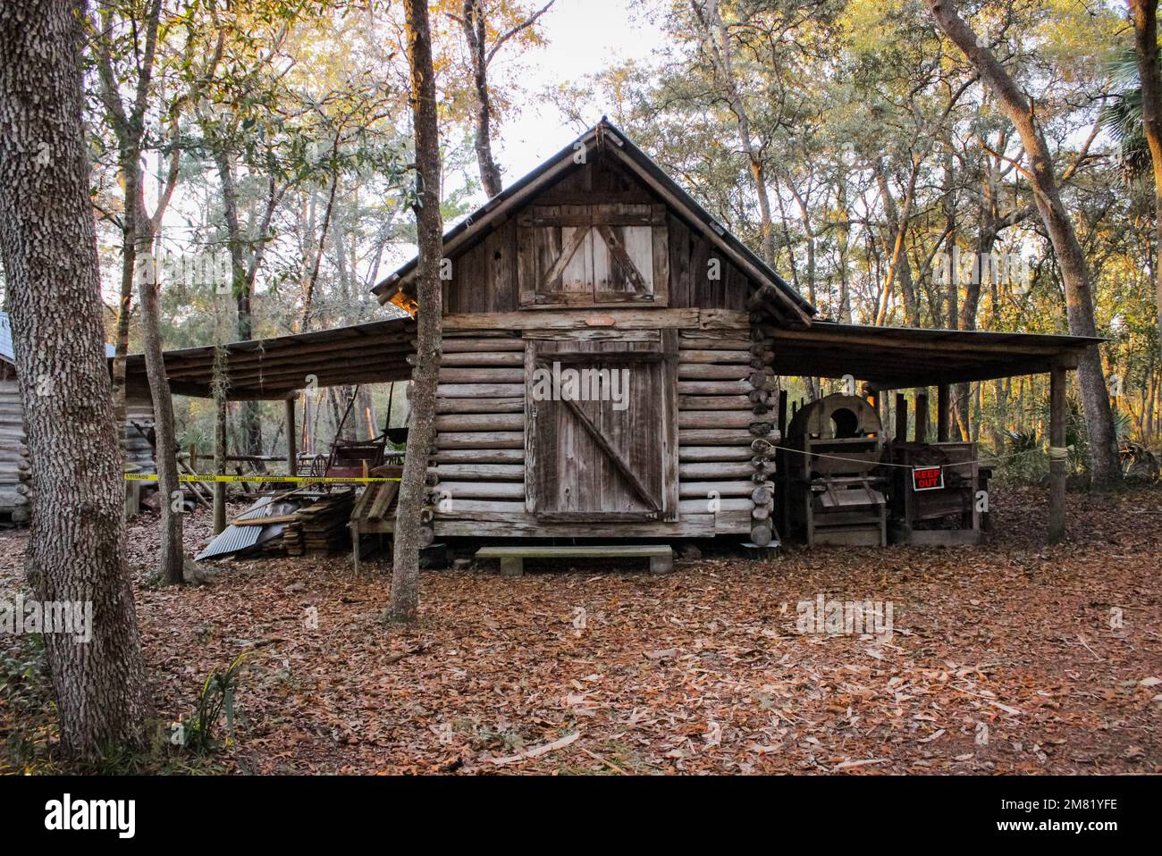 Mysterious barn may be dangerous per the caution tape and keep out sign ...