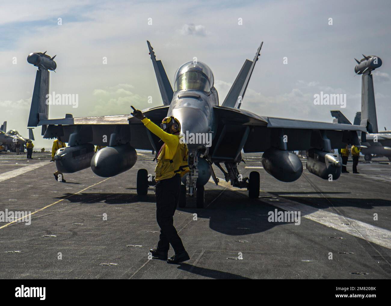 230110-N-MH015-1133 PHILIPPINE SEA (Jan. 10, 2023) A U.S. Navy Sailor directs an E/A-18G Growler ...