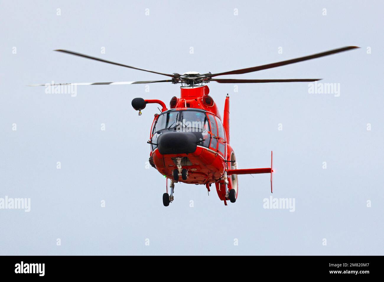 An MH-65 Dolphin helicopter takes flight during hoist rescue simulation ...