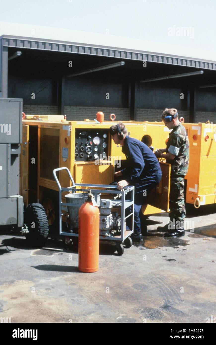 Two members of the Aircraft Intermediate Maintenance Department (AIMD ...