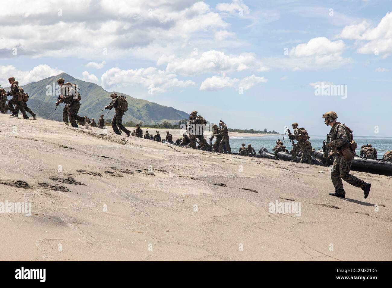U.S. Marines with Battalion Landing Team 2/5, 31st Marine Expeditionary Unit, assault forward at ...