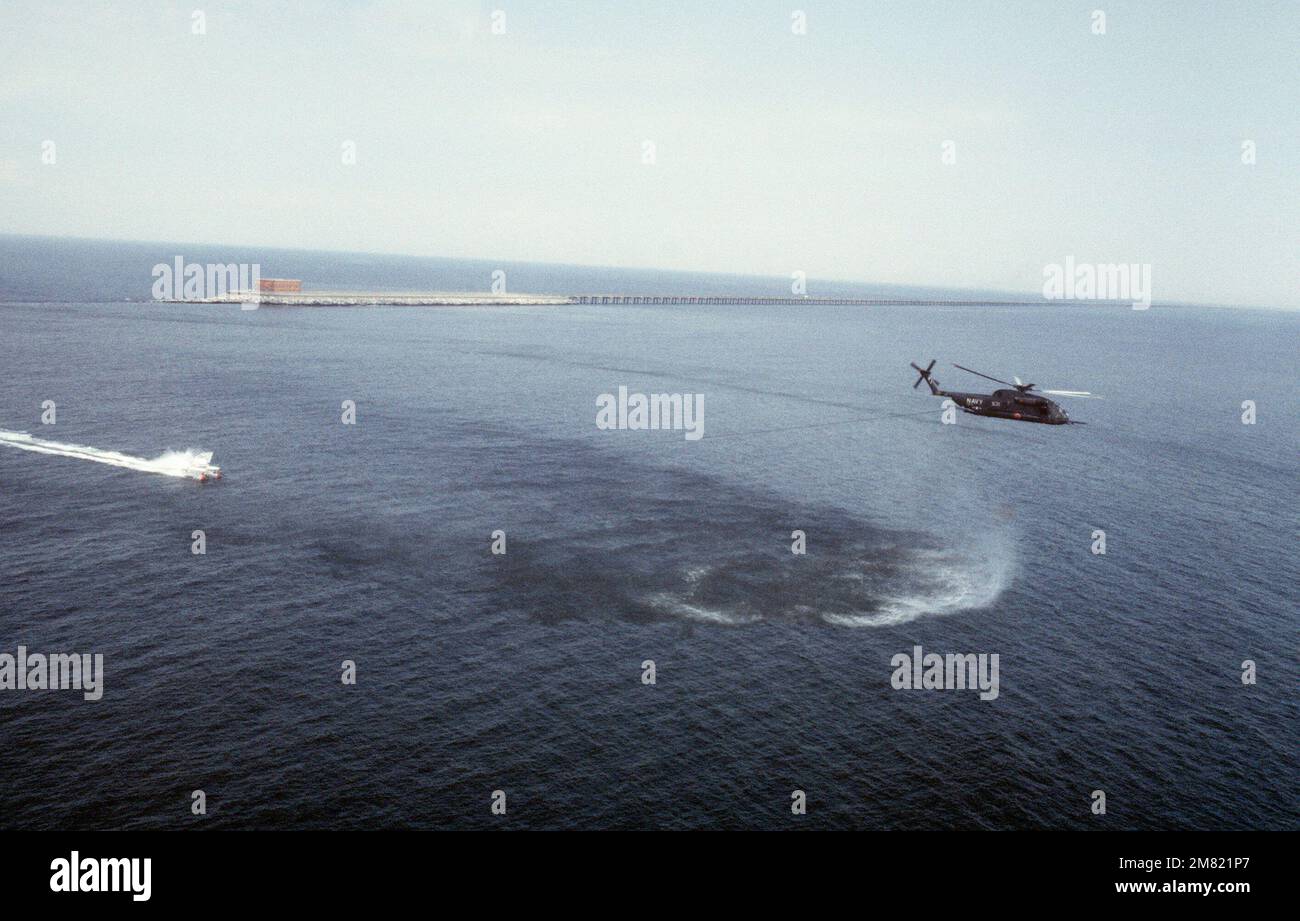 An air-to-air right side view of an RH-53D Sea Stallion towing a mine ...