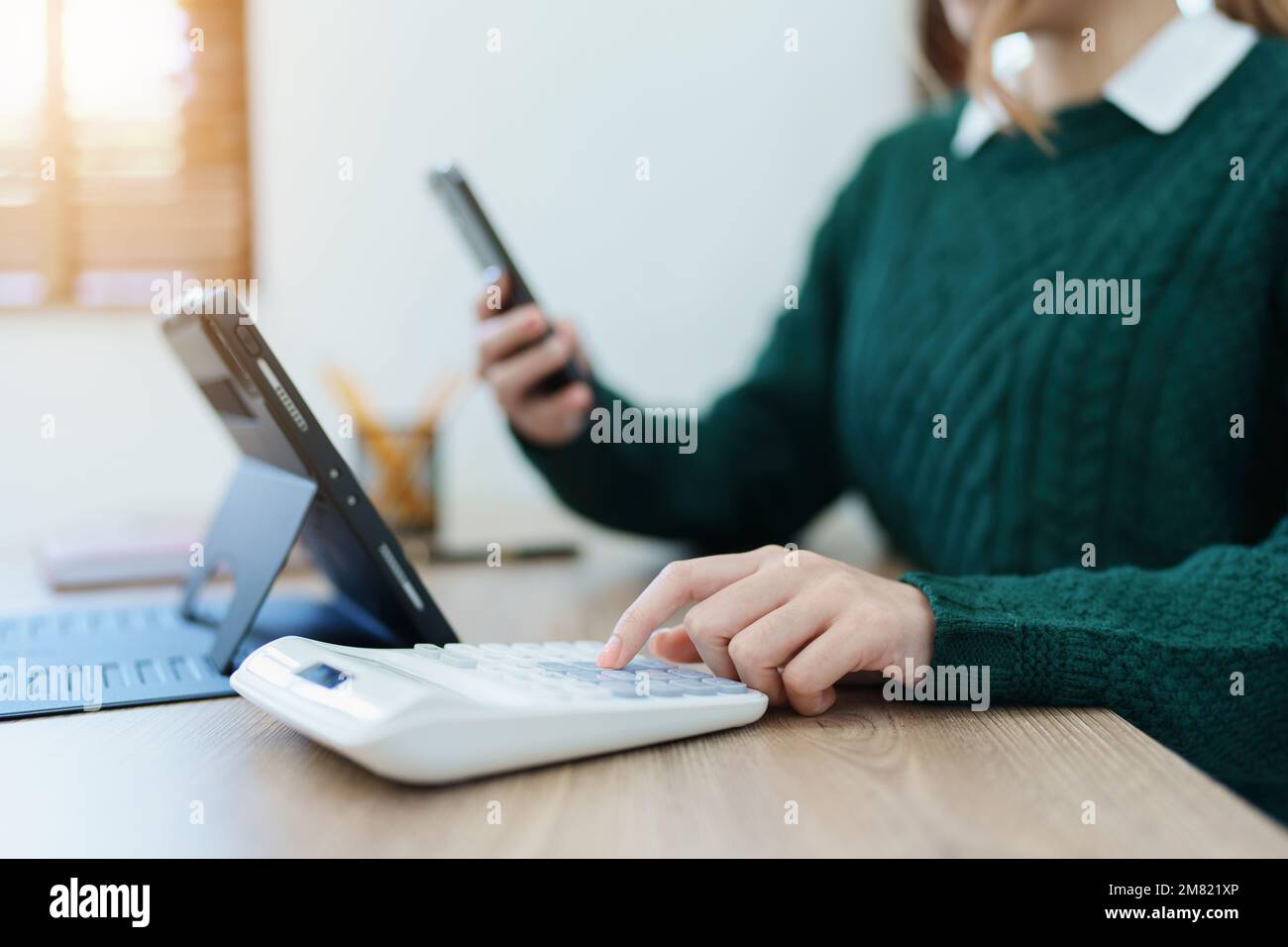 business owner or Asian male marketers are using smart phone and ...