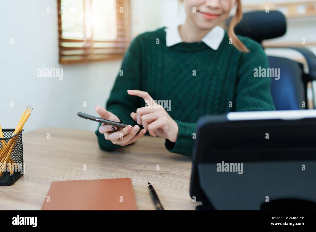 business owner or Asian male marketers are using smart phone and tablet ...