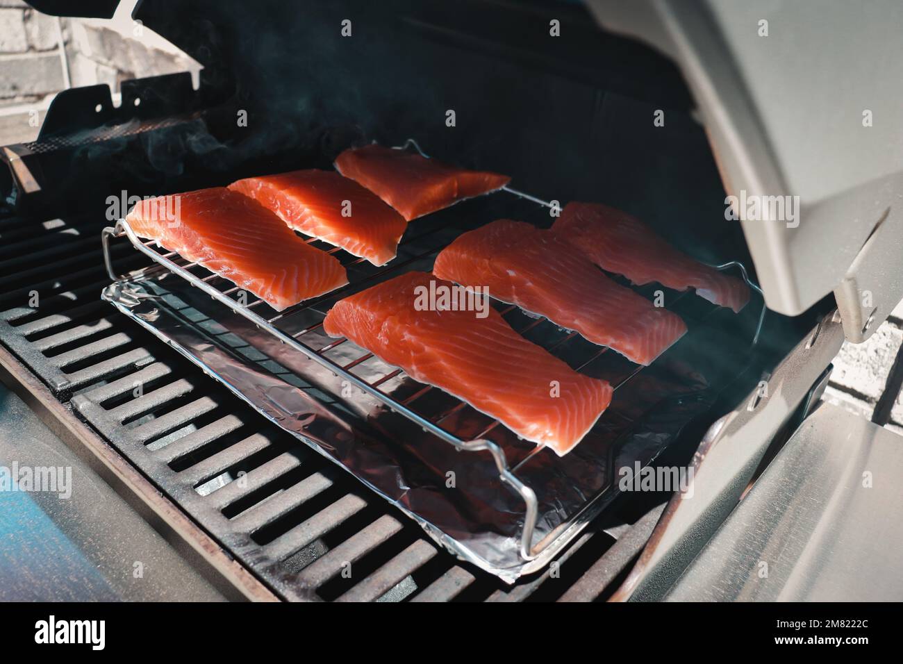 close up of fresh layman steaks on grill with smoke Stock Photo - Alamy