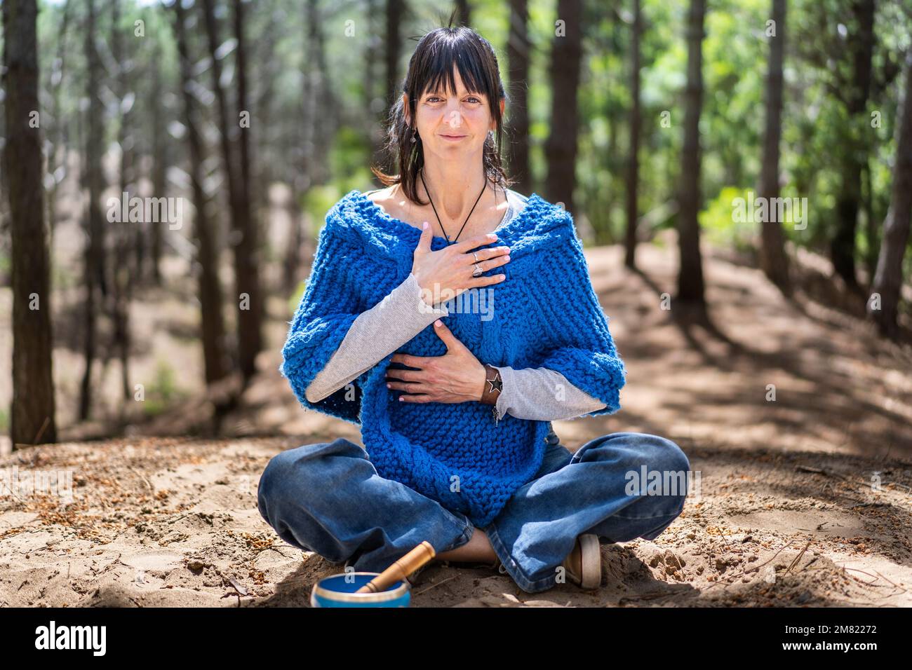 A smiling woman doing breathing exercises while looking at camera Stock ...