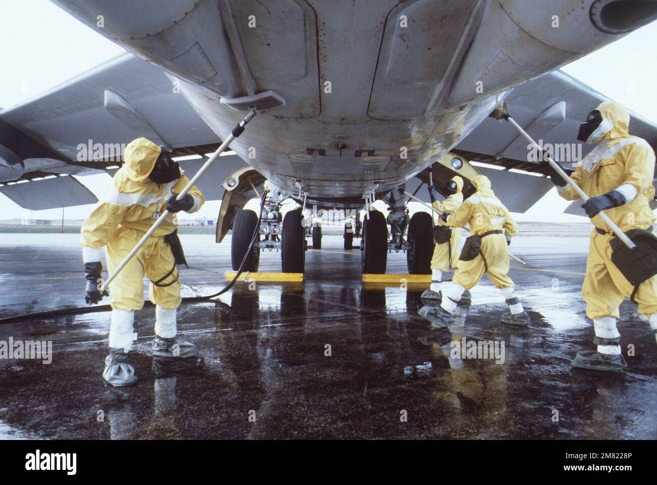 Ground crewmen, wearing nuclear-biological-chemical (NBC) clothing ...