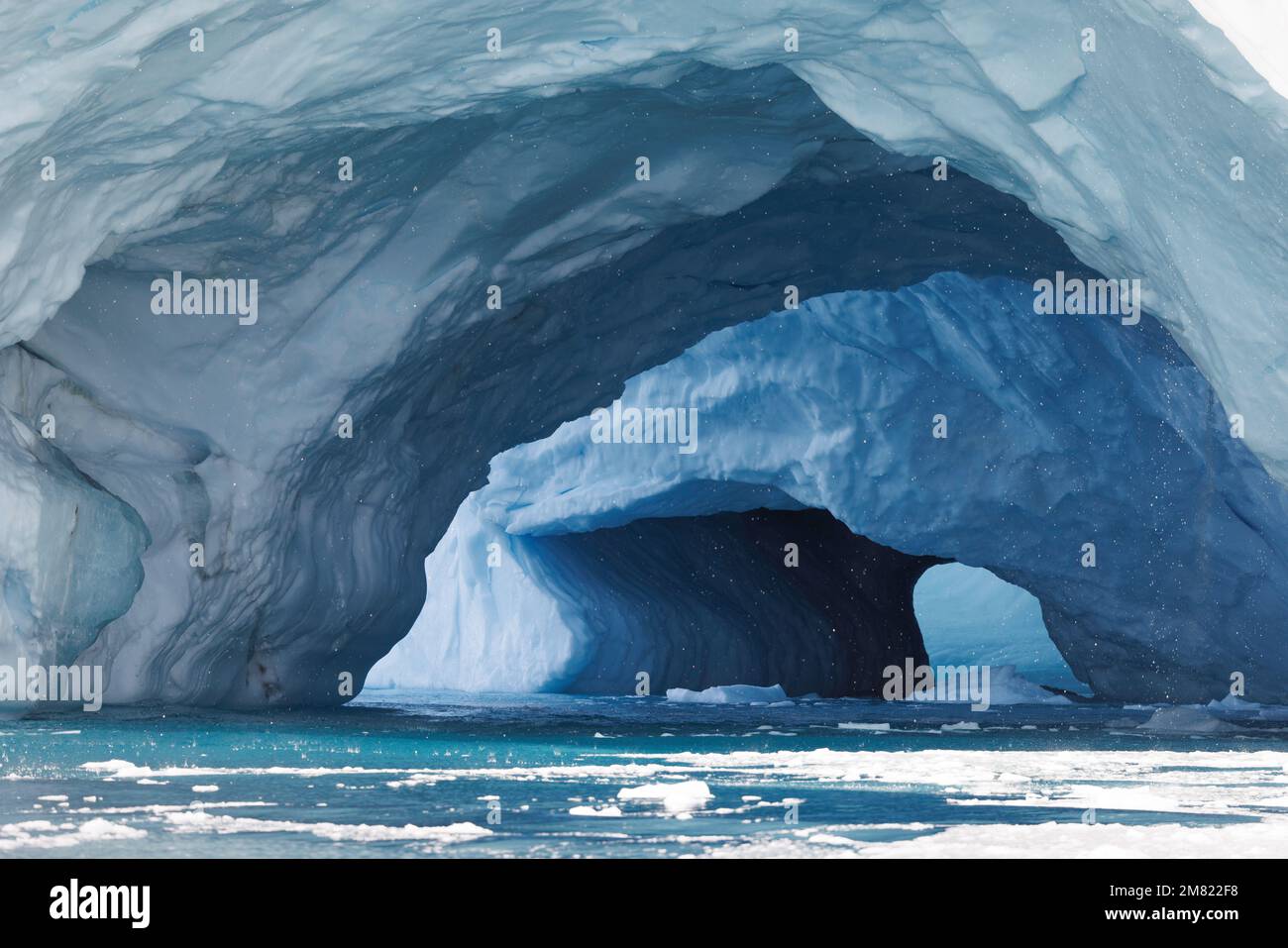double cave in big iceberg floating over sea Stock Photo - Alamy