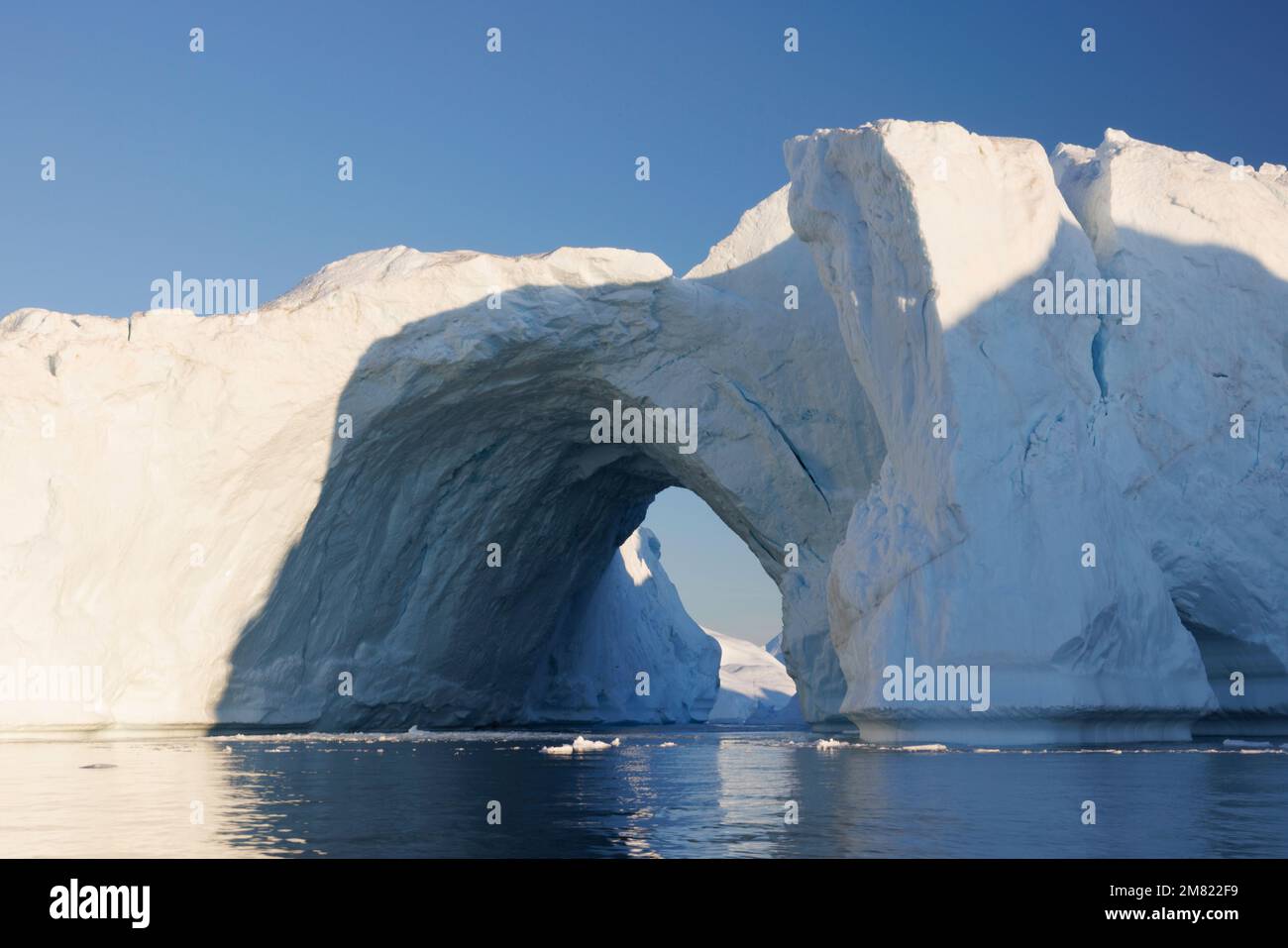extreme arch in big icebergs floating over sea Stock Photo - Alamy