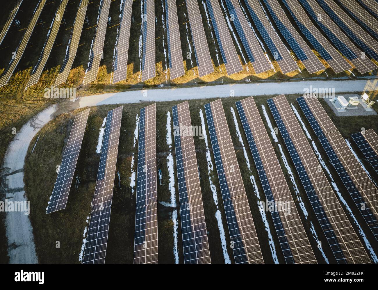 gravel road twists through renewable solar panel farm Stock Photo - Alamy
