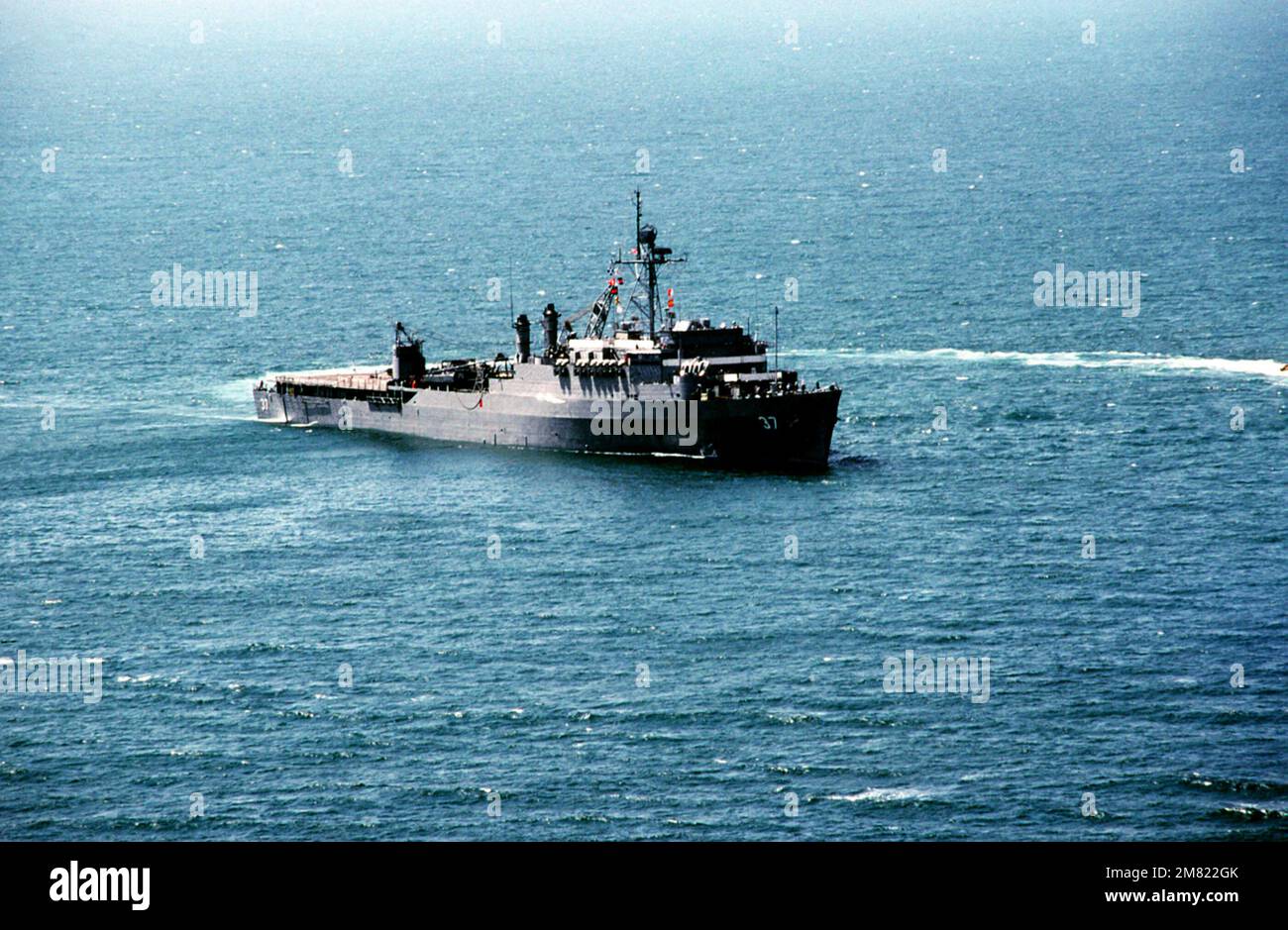An elevated starboard bow view of the dock landing ship USS PORTLAND ...