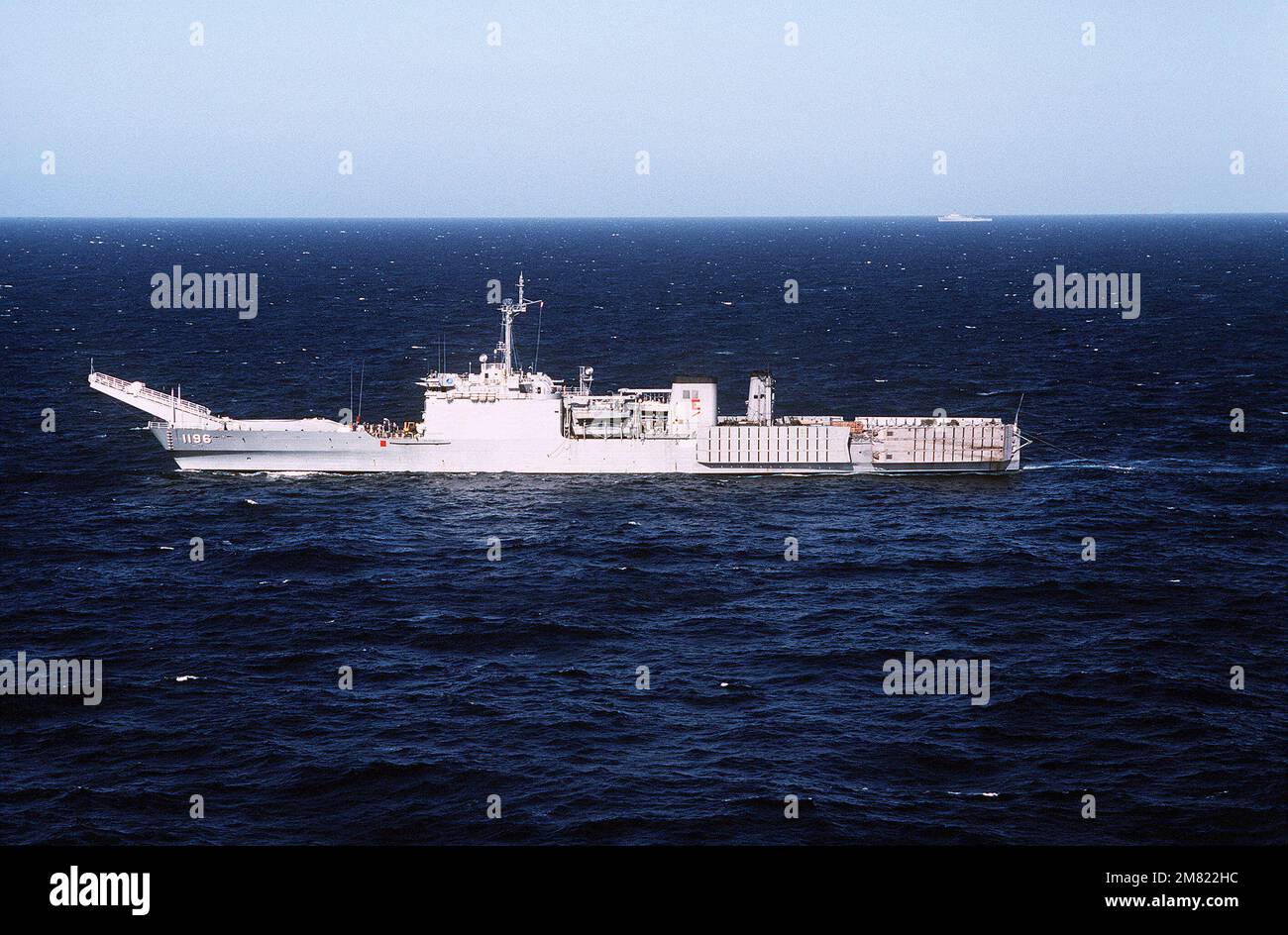An elevated port beam view of the tank landing ship USS HARLAN COUNTY ...