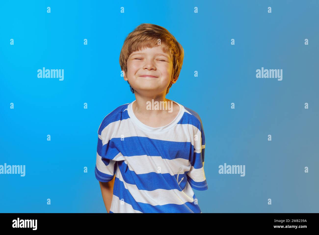 Joyful kid smiling. Studio shot on a blue and yellow background Stock ...