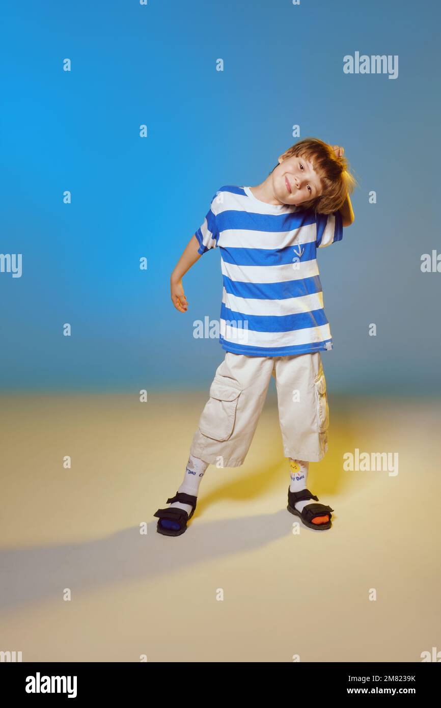 Joyful kid as sailor. Studio shot on a blue and yellow background Stock ...