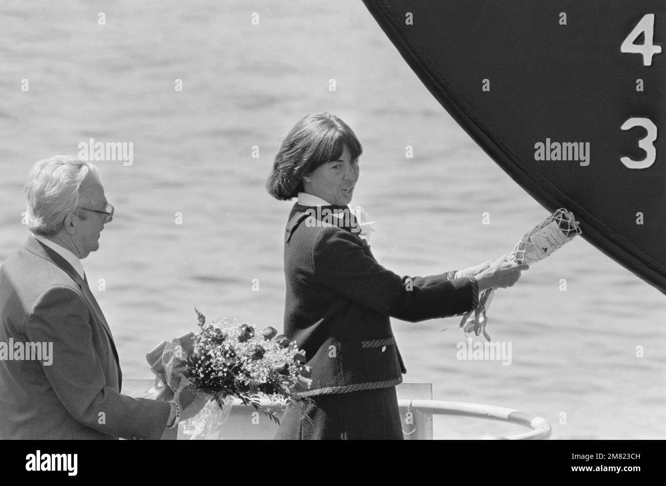 Mrs. Edward G. Waller III, sponsor, christens the Safeguard class ...