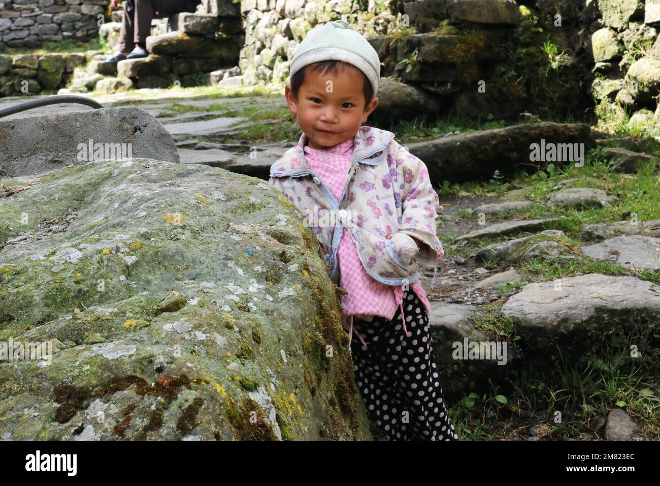 Kothe Village, Nepal, October 13th 2018 - A sherpa child enjoys a sunny ...