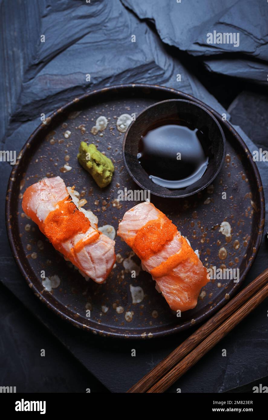 Burned salmon sushi with soy sauce and wasabi Stock Photo - Alamy