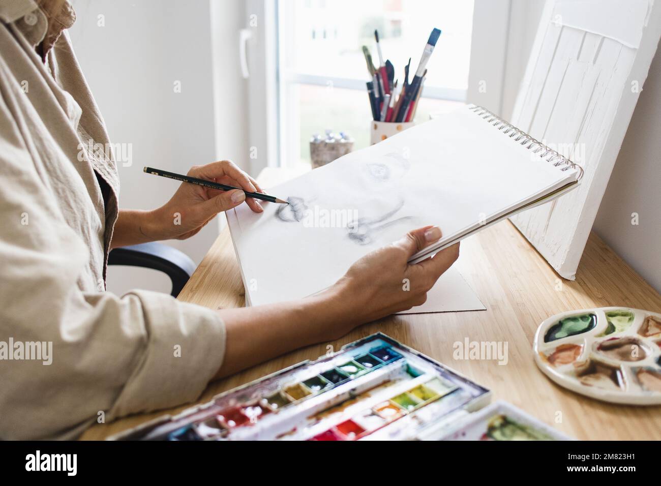 Woman Learning How to Draw at Home Holding Pencil Stock Photo - Alamy