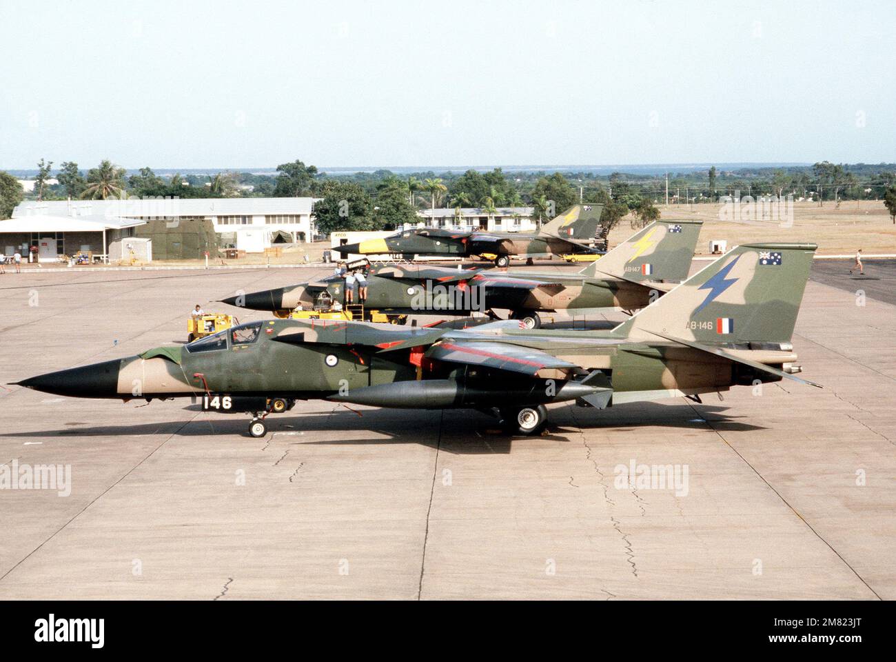 A left side view of three RAAF F-111 Fighter aircraft parked on the ...