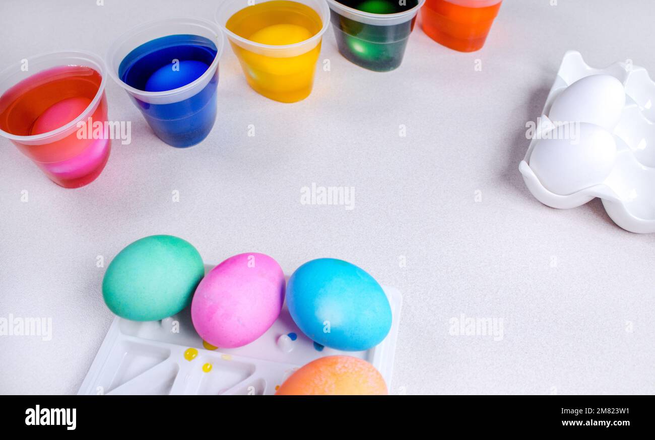 Tools for painting eggs for easter, eggs box, cups of colorful paint ...