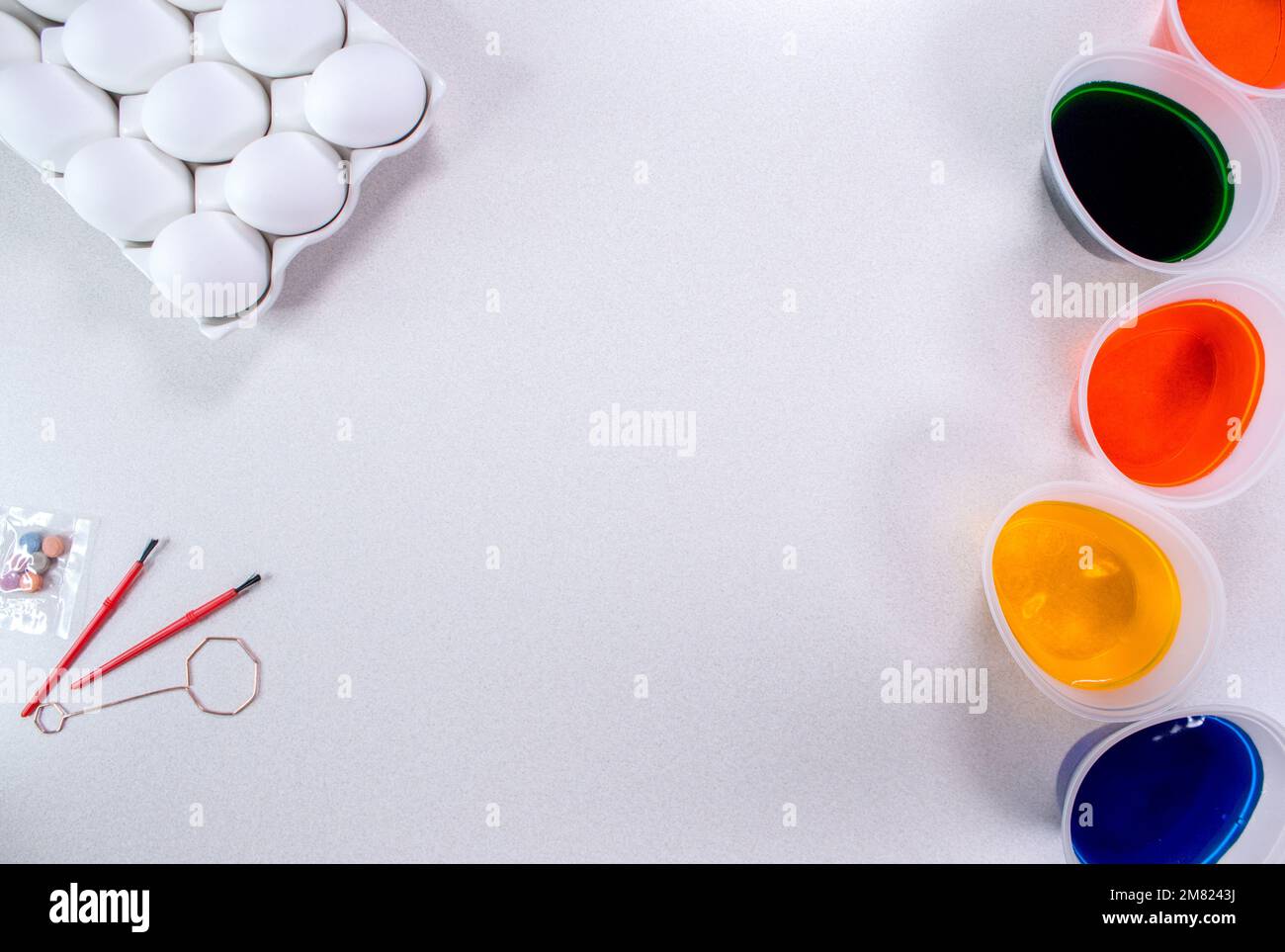 Tools for painting eggs for easter, eggs box, cups of colorful paint ...