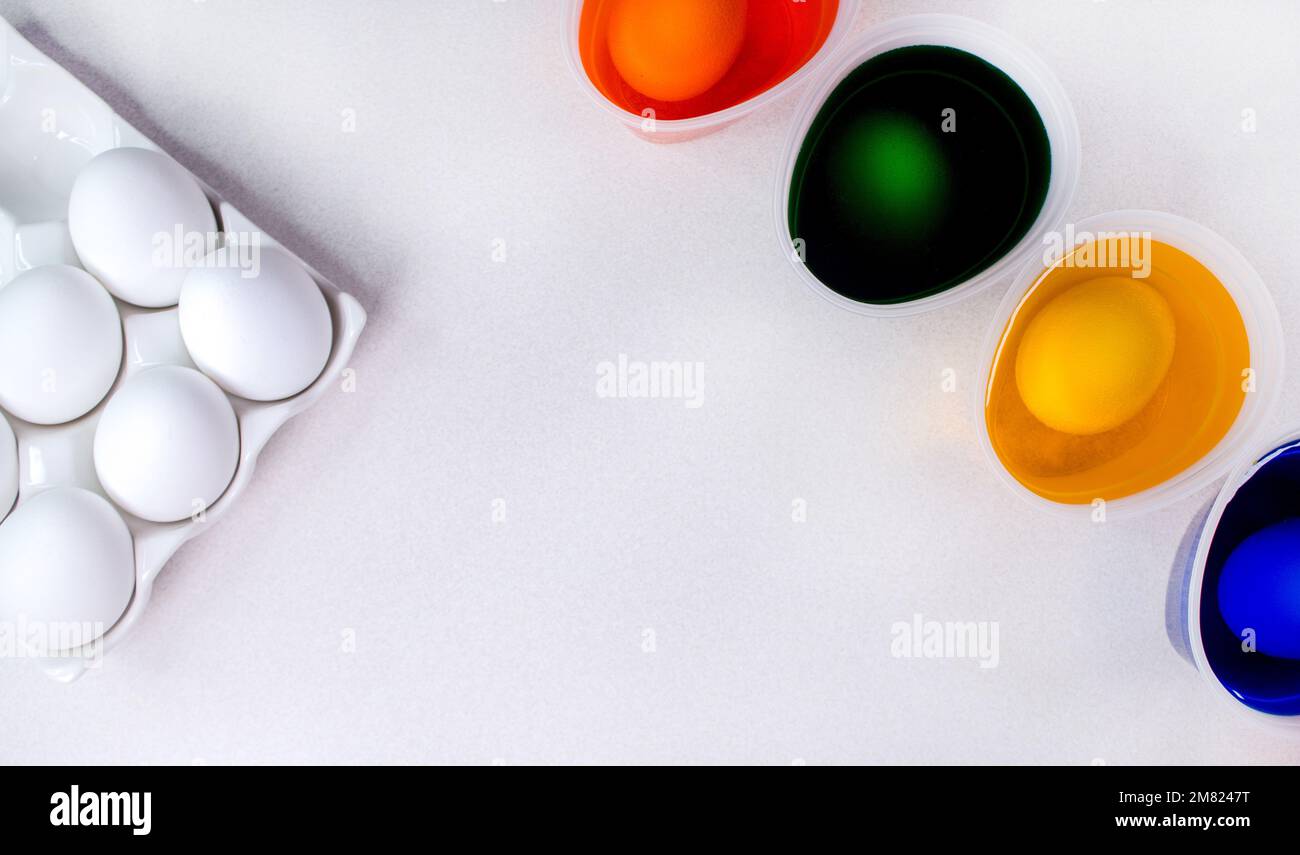Tools for painting eggs for easter, eggs box, cups of colorful paint ...