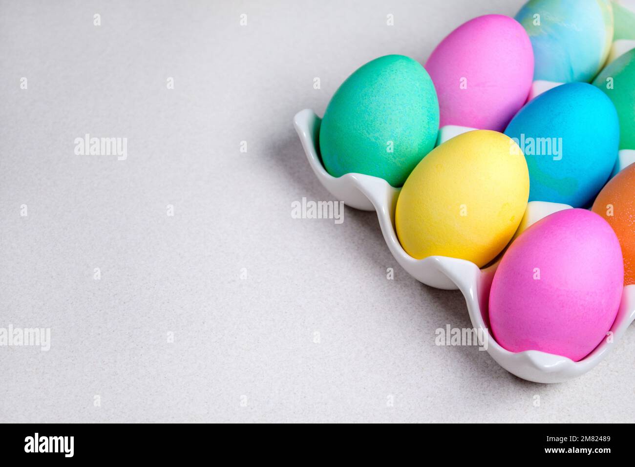 Pastel Easter eggs lying on white table. Traditional decoration Stock ...