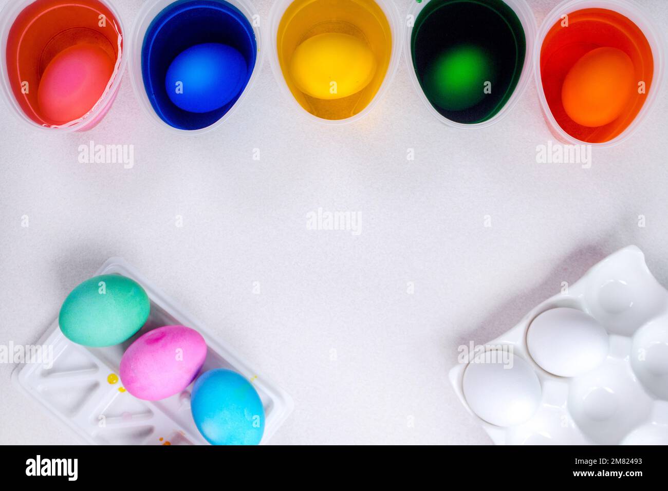Tools for painting eggs for easter, eggs box, cups of colorful paint ...