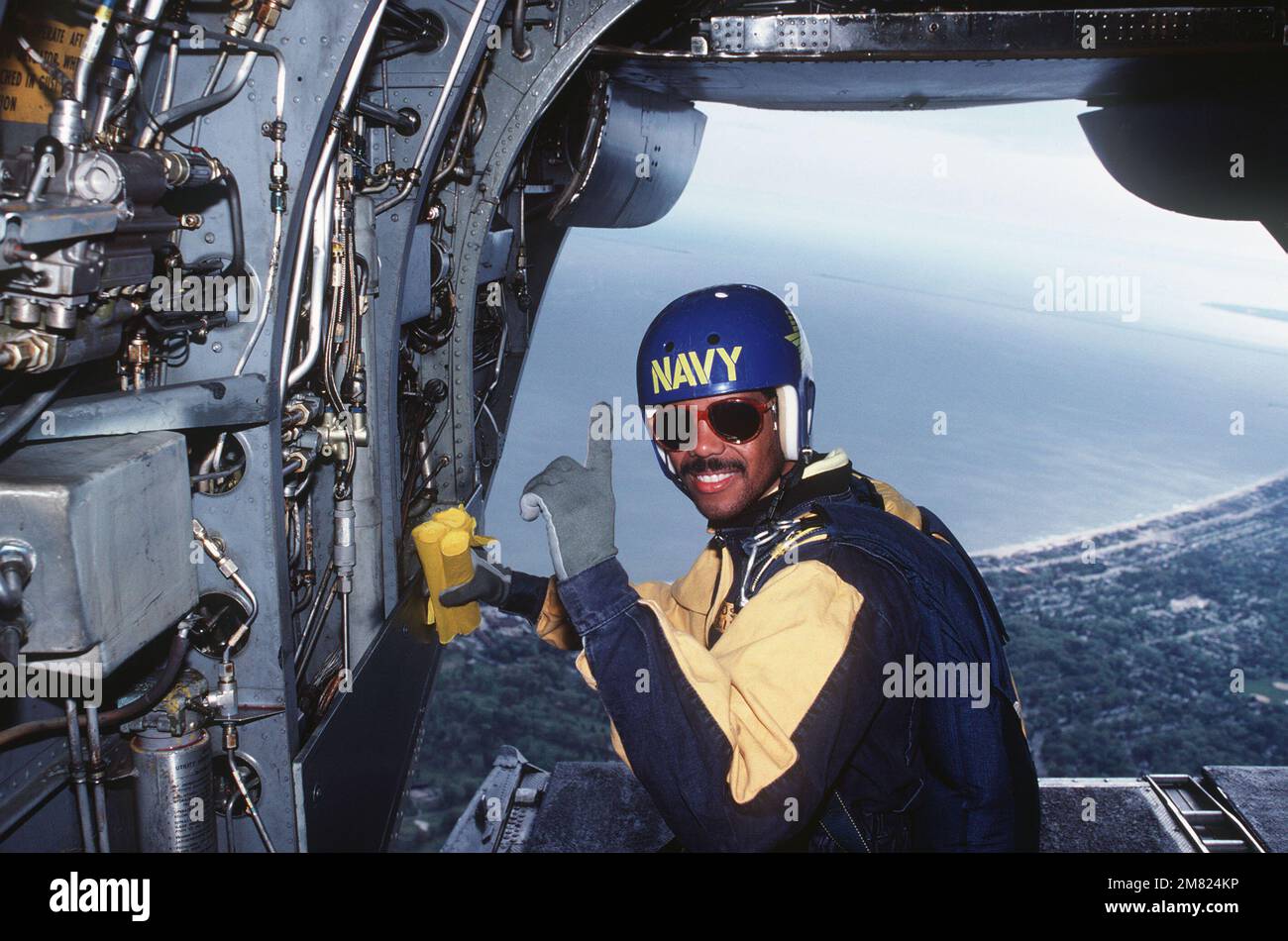 Personnelman 2nd Class Jose Olivo gives the one-minute signal to ...