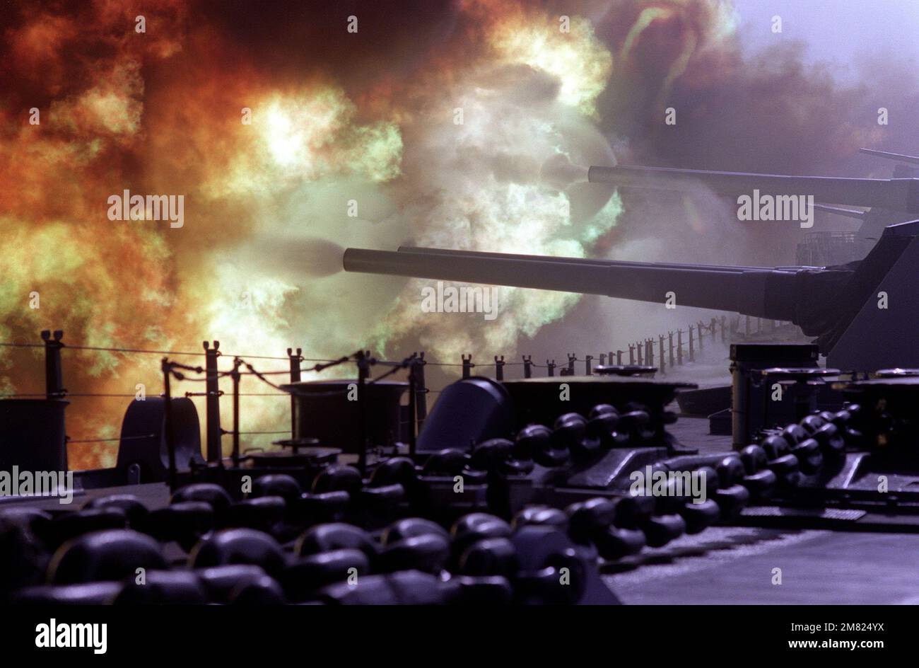 The battleship USS IOWA (BB-61) fires a salvo from its forward Mark 7 ...
