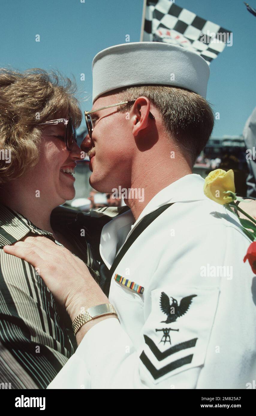 A fire control technician 2nd class (FT2) greets a loved one upon ...