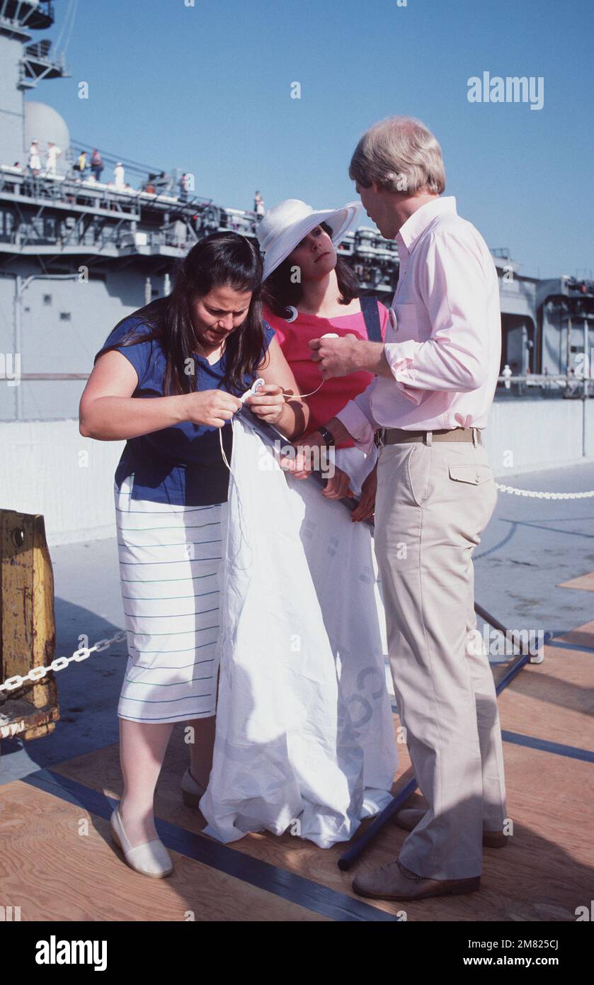 Joy and Pat Higginbotham prepare a banner to greet Lieutenant Junior ...