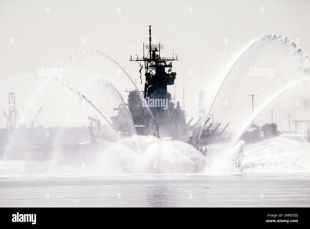 A fireboat spouts fountains of water during the homecoming of the ...