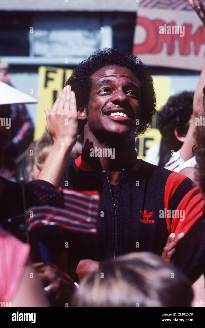 A man waits at dockside to greet a crew member aboard the battleship ...