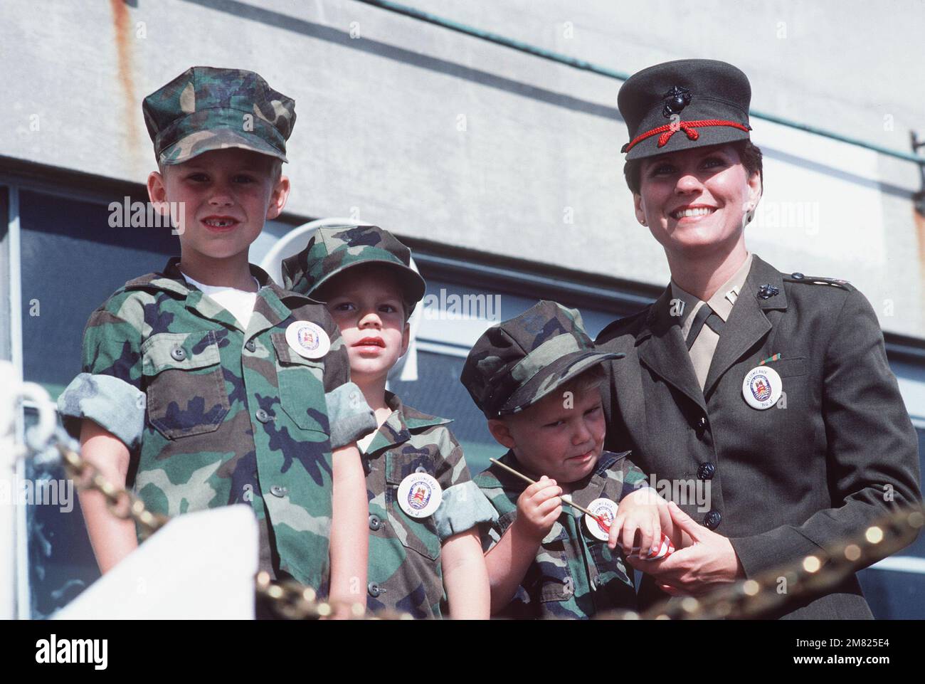 The wife and sons of Captain Mike Hicks, Marine Detachment, wait to ...