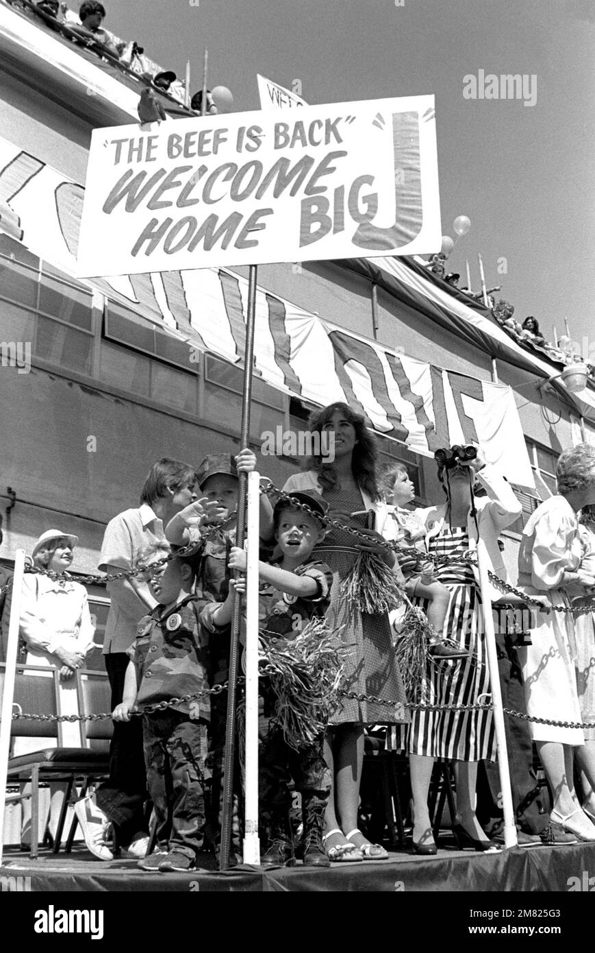 Three fatigue-clad boys hold up a sign announcing, "The Beef Is Back ...