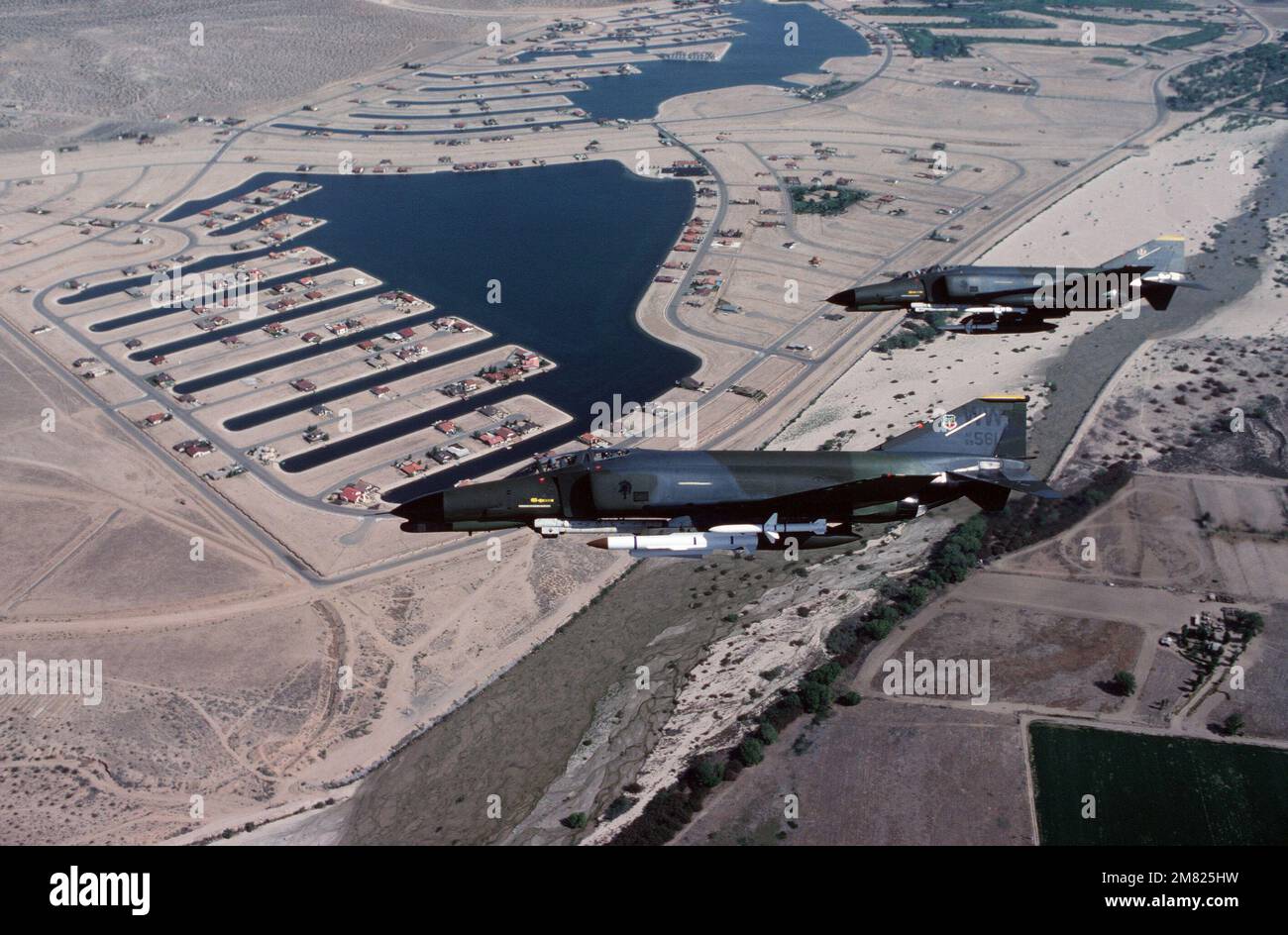 A left side view of an F-4G Advanced Wild Weasel Phantom II and an F-4E ...