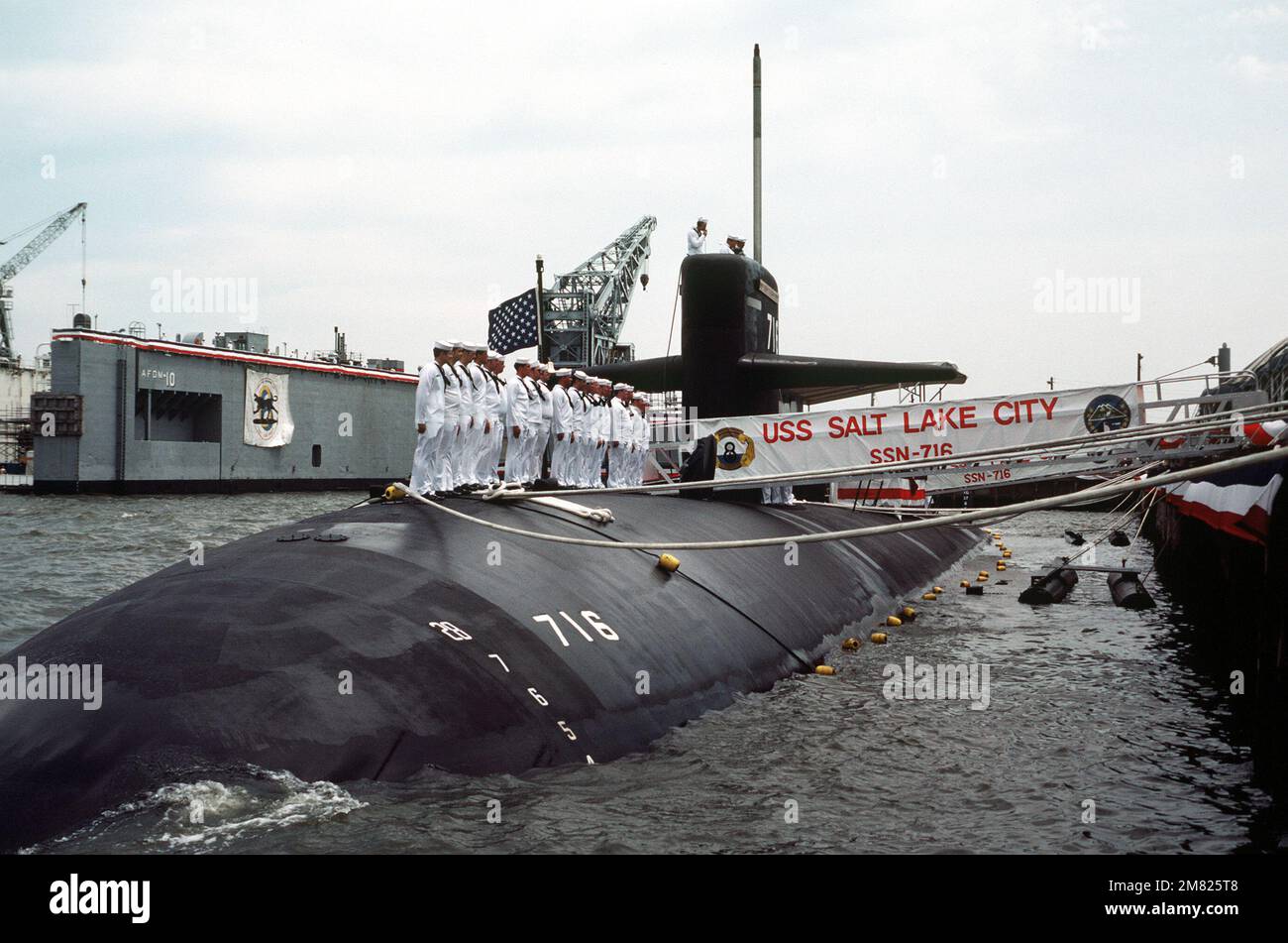 Crew members stand at attention on deck during the commissioning ...