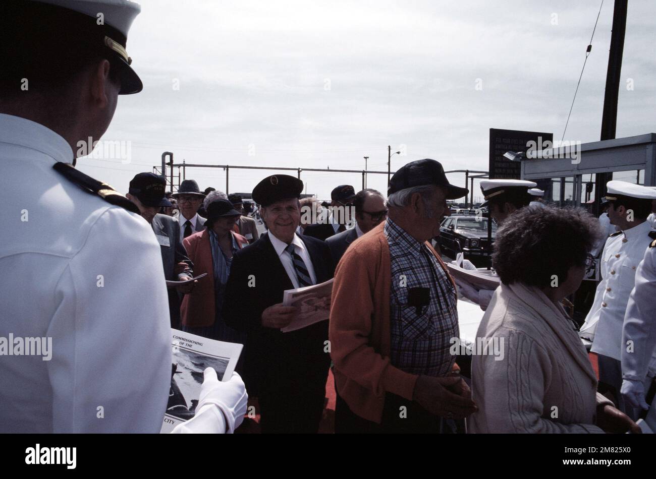 Junior officers distribute programs to guests attending the ...