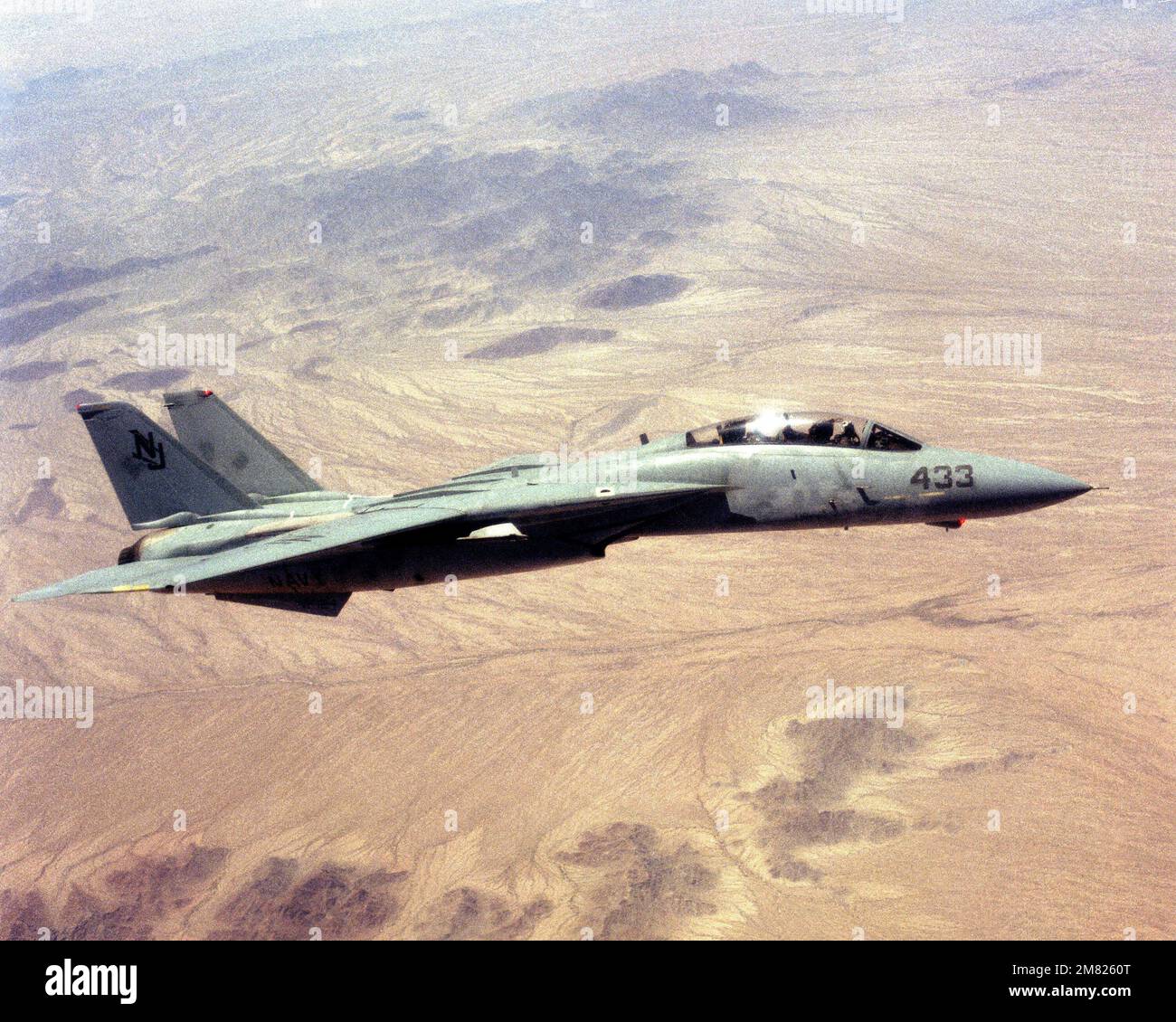 An air-to-air right side view of two Fighter Squadron 124 (VF-124) F-14 ...